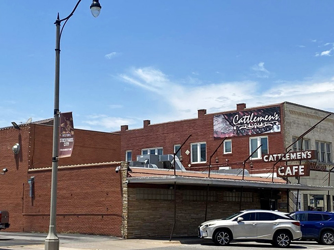 The brick facade of Cattlemen's stands proudly in Oklahoma City's Stockyards, a carnivore's lighthouse beckoning hungry travelers through decades of beef-loving history.