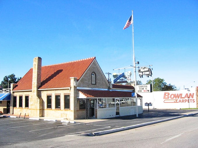 The iconic orange roof and stone exterior of Van's Pig Stand stands as a beacon of barbecue hope on Shawnee's horizon, promising smoky delights within.