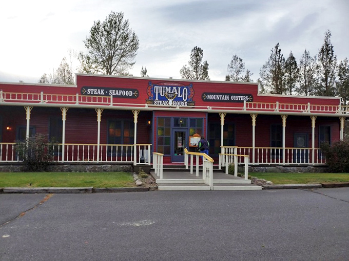The red facade of Tumalo Feed Co. stands like a Western mirage against the Oregon sky, beckoning hungry travelers with promises of carnivorous delights. 