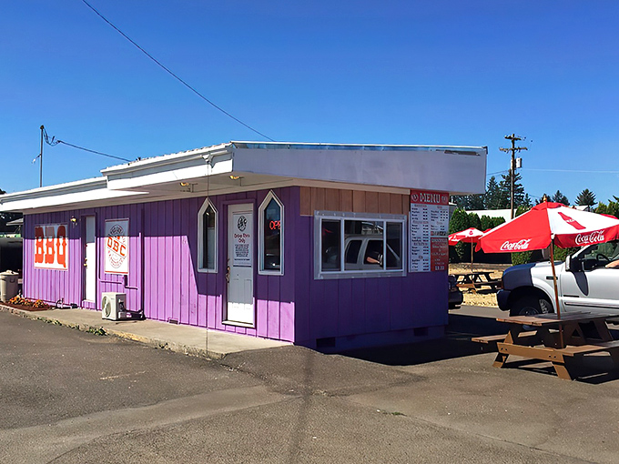 The unmistakable purple exterior of Oregon Barbecue Company stands out like a beacon for hungry travelers, promising smoky delights within. 