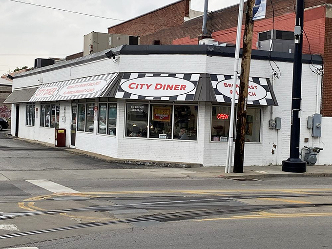 The classic white brick exterior with black and white striped awning stands like a time capsule on this Kansas City corner, beckoning hungry patrons with its humble charm.
