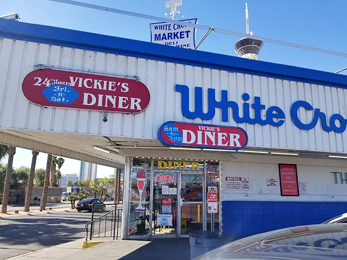 The unmistakable red-and-white exterior of Vickie's Diner stands like a time capsule amid the desert landscape, promising comfort food salvation to weary Vegas travelers.