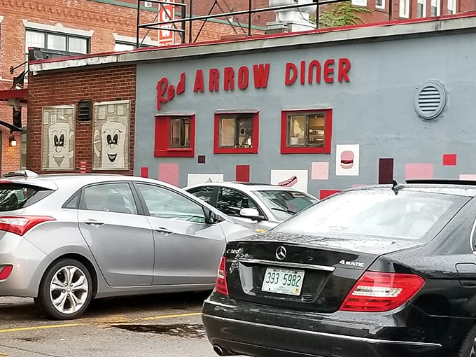 The iconic Red Arrow Diner storefront beckons hungry travelers with its vintage neon sign and promise of 24-hour comfort food. Manchester's brick-and-mortar time machine awaits.