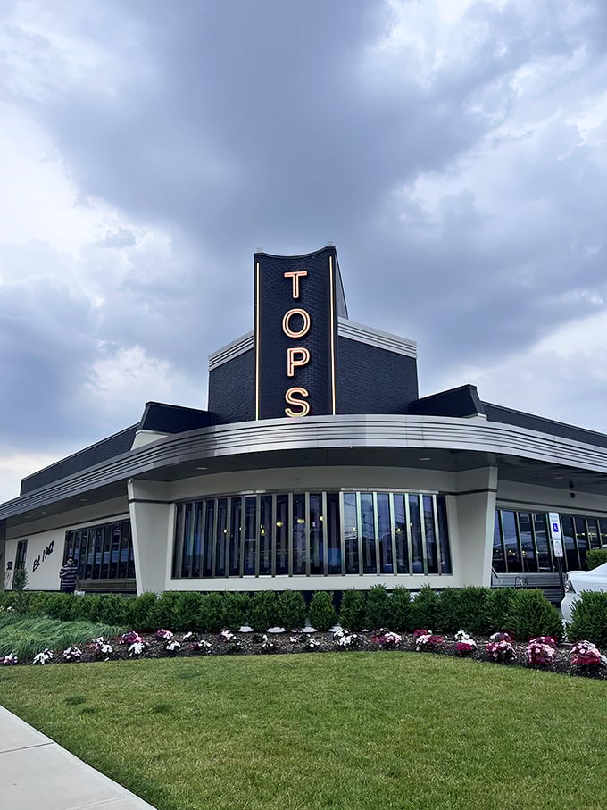 The gleaming Art Deco exterior of Tops Diner stands like a chrome-plated time machine, promising comfort food that transcends eras. New Jersey's diner royalty awaits.