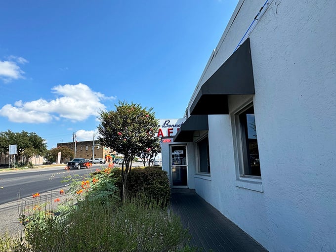 The white exterior with its classic blue and red signage isn't just a restaurant facade—it's a promise of comfort that's been kept for generations of Texans.
