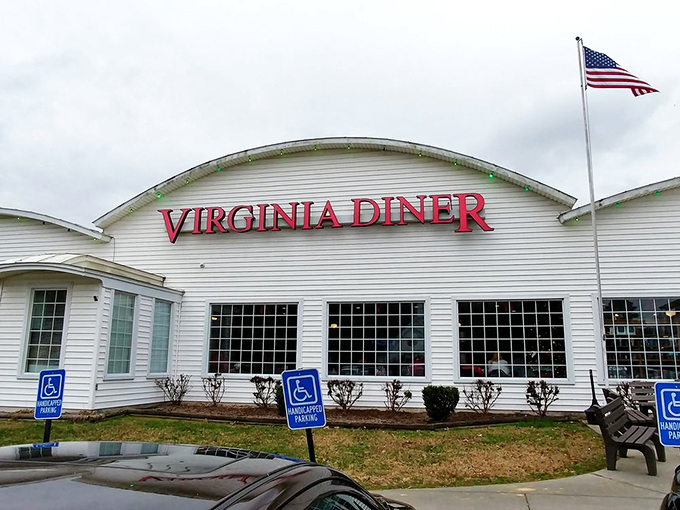 The white curved-roof building with bold red "VIRGINIA DINER" lettering stands proudly against the sky, like a beacon of comfort food calling road-weary travelers home.