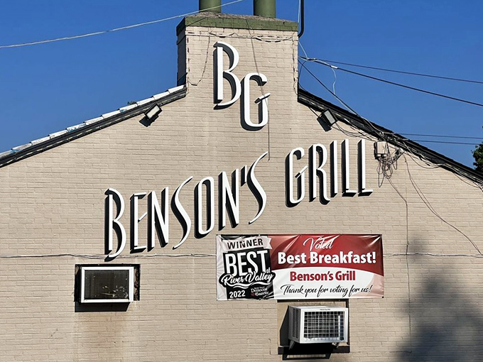 The parking sign says it all &ndash; this isn't just a meal, it's a destination worth navigating to. Benson's Grill beckons hungry travelers under clear Arkansas skies.