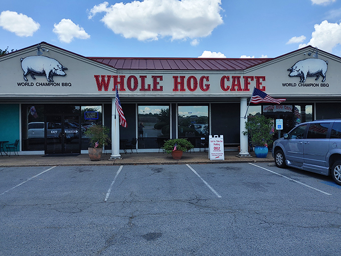 The barbecue beacon of North Little Rock stands proud with its red roof and pig silhouettes, boldly declaring its championship status to hungry passersby.