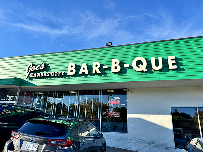 The green facade of barbecue paradise beckons like a smoky mirage. Who knew a gas station could house such legendary meaty treasures?