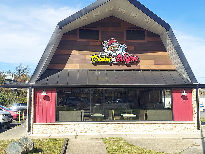 The distinctive peaked roof and cartoon sign of Country Style Chicken And Waffles beckons hungry travelers like a lighthouse for comfort food enthusiasts.