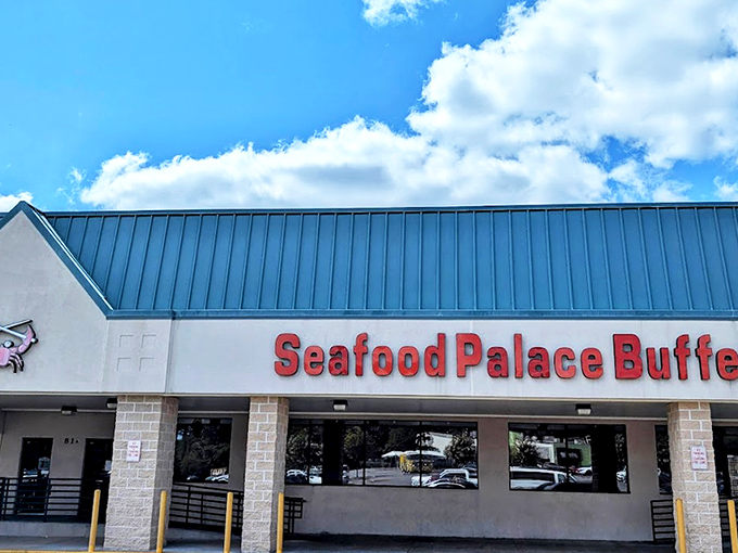 The unassuming exterior of Seafood Palace Buffet stands like a seafood speakeasy, its little crab logo promising treasures that belie its strip mall location.