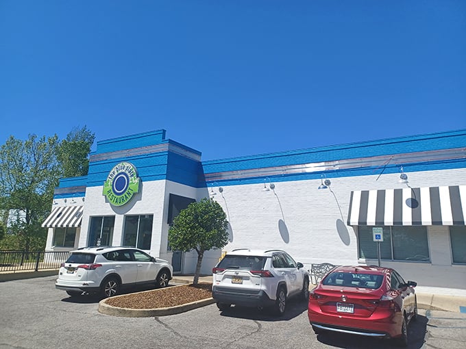 The Blue Plate's vibrant exterior stands out like a beacon of culinary hope. That bright blue and white building promises Southern comfort before you even step inside.