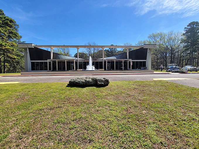 The modernist architecture of the Museum of Automobiles stands like a mid-century time capsule against Arkansas's lush greenery, complete with a welcoming fountain.