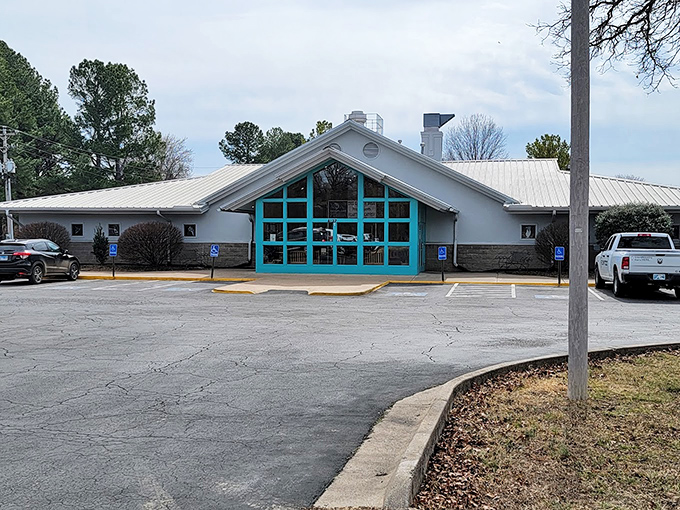 The teal-framed A-frame entrance isn't just inviting&mdash;it's practically winking at you to come inside for a catfish adventure.