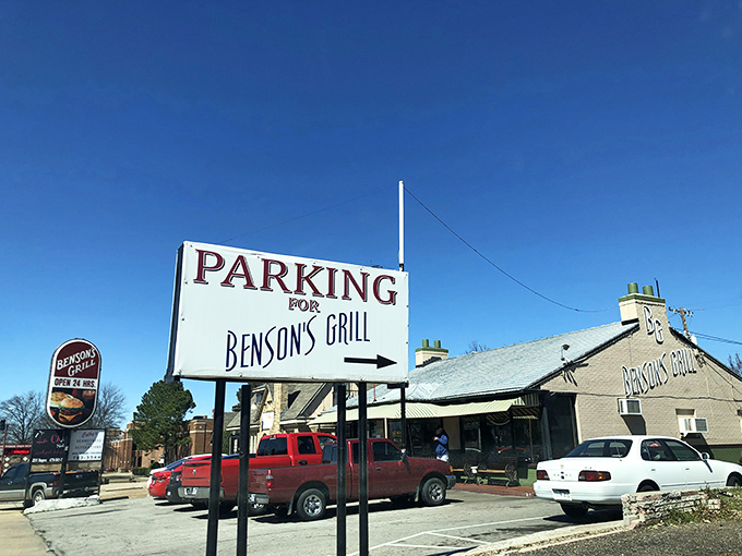 The parking sign says it all &ndash; this isn't just a meal, it's a destination worth navigating to. Benson's Grill beckons hungry travelers under clear Arkansas skies.
