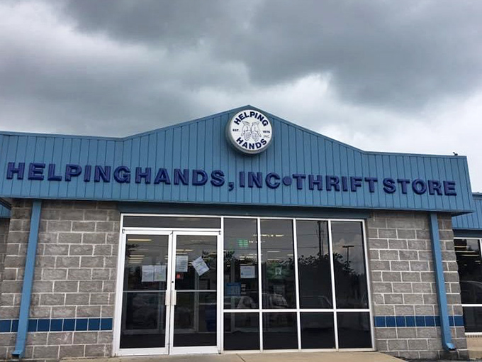 The bright blue facade of Helping Hands stands like a beacon of bargain-hunting hope against the Arkansas sky, promising treasures within.