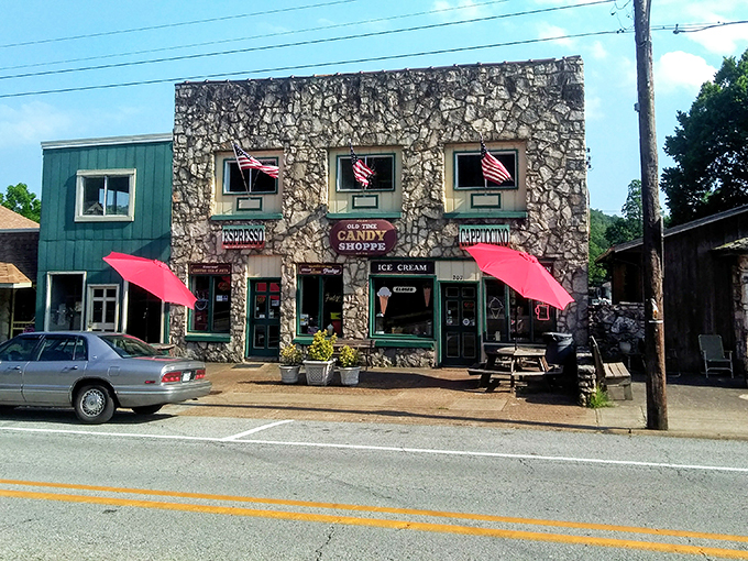 The stone facade of Hardy Sweet Shop stands like a sugar-dusted fortress, those cheery red awnings practically shouting "abandon diets, all ye who enter here!"