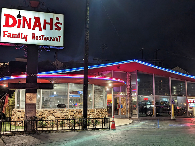 The iconic A-frame and vintage sign of Dinah's stand proud against the LA skyline, a time capsule of mid-century dining glory.