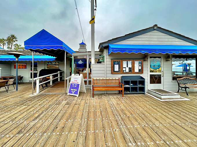 The blue awnings of The Fisherman's Restaurant pop against the San Clemente sky, beckoning hungry visitors like a maritime mirage on the historic pier.