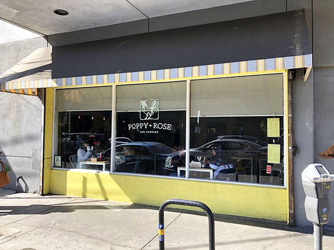 The sunshine-yellow exterior of Poppy + Rose beckons like a culinary lighthouse amid downtown LA's Flower District, promising comfort food worth the journey.