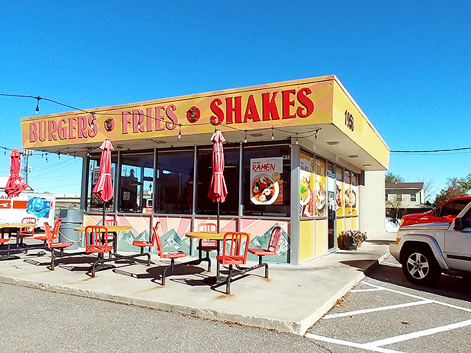 The sunshine-yellow exterior of Big Sky Burger stands out like a beacon for hungry travelers, promising simple pleasures with its no-nonsense "BURGERS &bull; FRIES &bull; SHAKES" declaration.