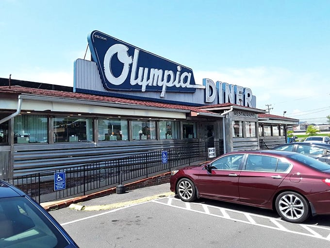 The gleaming stainless steel exterior of Olympia Diner stands as a chrome-plated time capsule on the Berlin Turnpike, beckoning hungry travelers since 1954.
