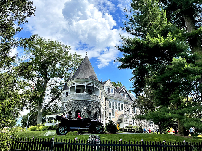 Auburn Heights mansion stands like a Victorian dream, its turret and wrap-around porch whispering tales of Gilded Age splendor and steam-powered adventures.