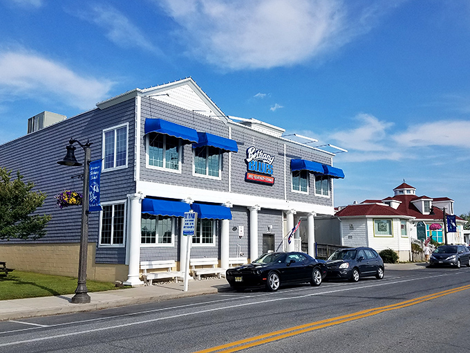 The coastal charm of Bethany Blues' exterior, with its distinctive blue awnings and gray shingles, beckons hungry travelers like a barbecue lighthouse on Delaware's shore.