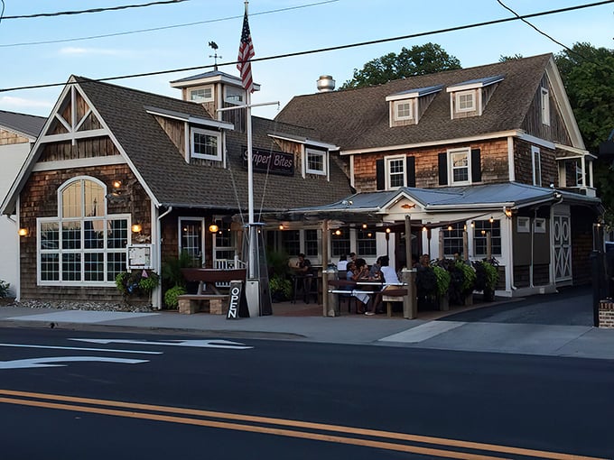 Striper Bites' cedar-shingled exterior feels like a coastal hug, with its welcoming porch and lush greenery inviting you to kick back and stay awhile.