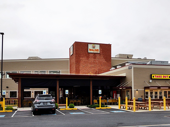 The iconic red and yellow awning of Nicola Pizza stands as a beacon of comfort food in Rehoboth Beach, promising culinary treasures within those brick walls.