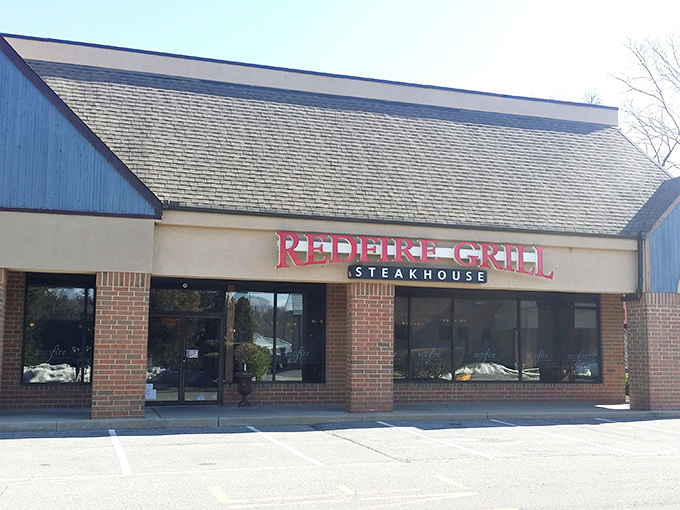 The unassuming exterior of Redfire Grill & Steakhouse proves once again that the best culinary treasures often hide in plain sight.