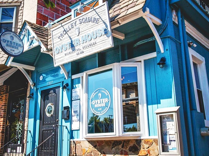 The blue fa&ccedil;ade of Trolley Square Oyster House stands like a maritime beacon in Wilmington, promising seafood treasures within those weathered wooden signs.