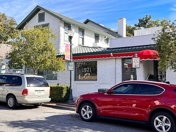A welcoming white archway leads to culinary paradise, where even the dog statue seems to be saying, "Trust me, you're going to love this place."