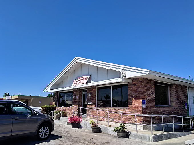 The unassuming brick exterior of Dixie Fried Chicken stands like a culinary lighthouse in Belle Glade, promising comfort food salvation to those in the know.