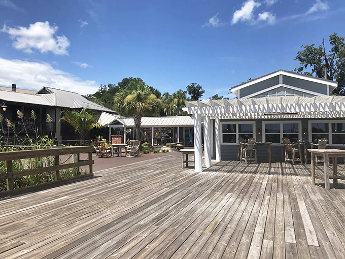 The welcoming pavilion entrance to Skippers Fish Camp beckons like a coastal siren song, promising seafood treasures just beyond those white columns.