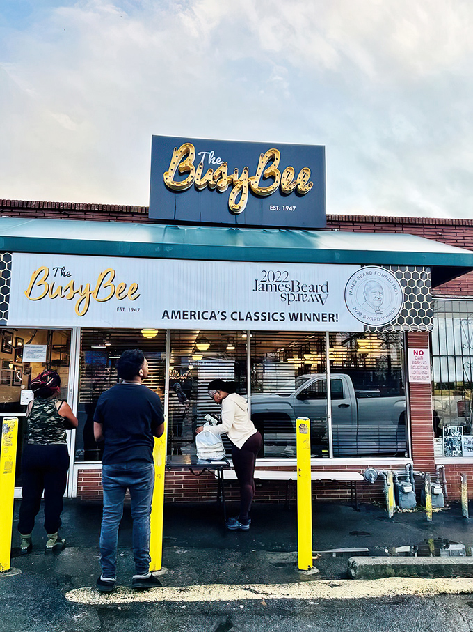 The iconic blue and yellow sign beckons hungry pilgrims like a Southern food lighthouse. The James Beard award banner confirms what locals already knew: this place is legendary.