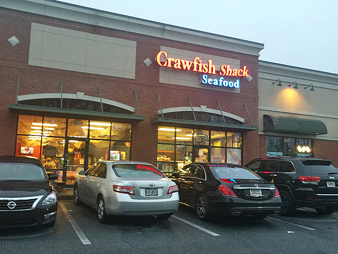 The red neon sign beckons like a lighthouse for seafood lovers. Strip mall location, zero pretension—just the promise of oceanic treasures within.