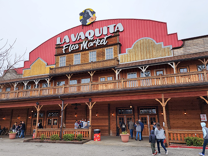 The iconic red-roofed facade of La Vaquita welcomes treasure hunters with its Western-style porch and watchful cartoon cow mascot overhead.
