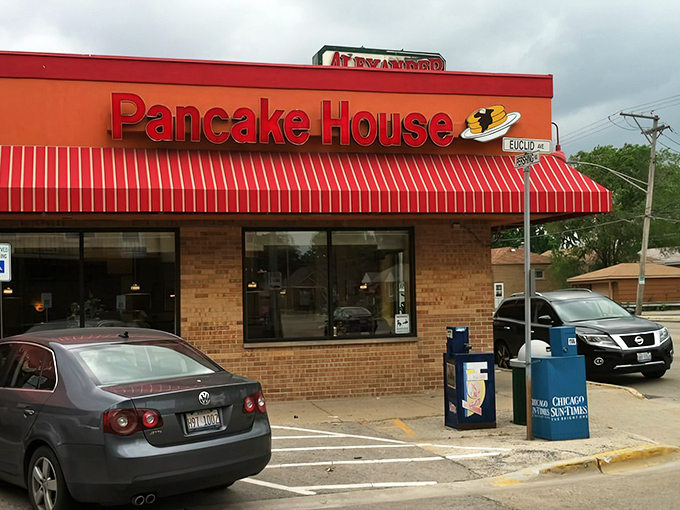 The iconic red awning of Alexander's stands out like a breakfast lighthouse, beckoning hungry travelers with its promise of pancake perfection.