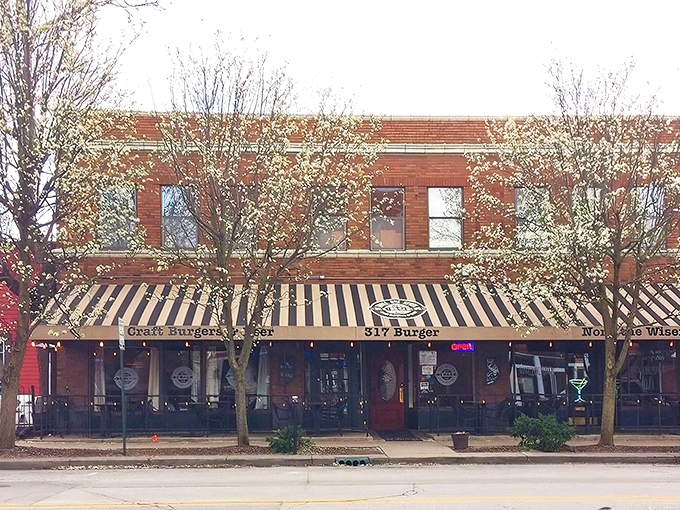 The iconic black and gold striped awning of 317 Burger beckons hungry travelers like a lighthouse for the famished. "Craft Burgers & Beer" isn't just a promise—it's a mission statement.