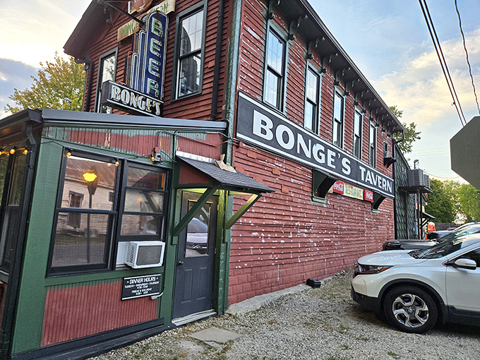 The unassuming exterior of Bonge's Tavern stands like a culinary secret hiding in plain sight, its weathered red siding and humble signage belying the gastronomic treasures within.