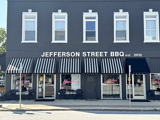 The classic black exterior with striped awnings isn't just charming&mdash;it's a beacon calling to barbecue pilgrims from across Indiana. Small-town magic with big-time flavor.