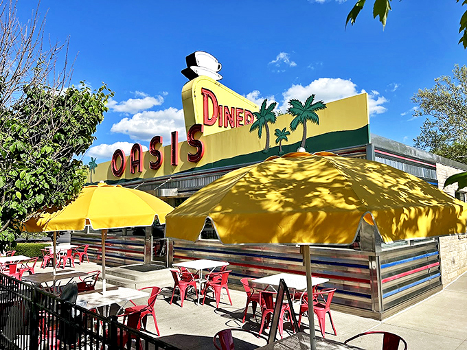 The classic stainless steel and stone exterior of The Oasis Diner stands like a time capsule on Plainfield's landscape, its iconic yellow sign beckoning hungry travelers.