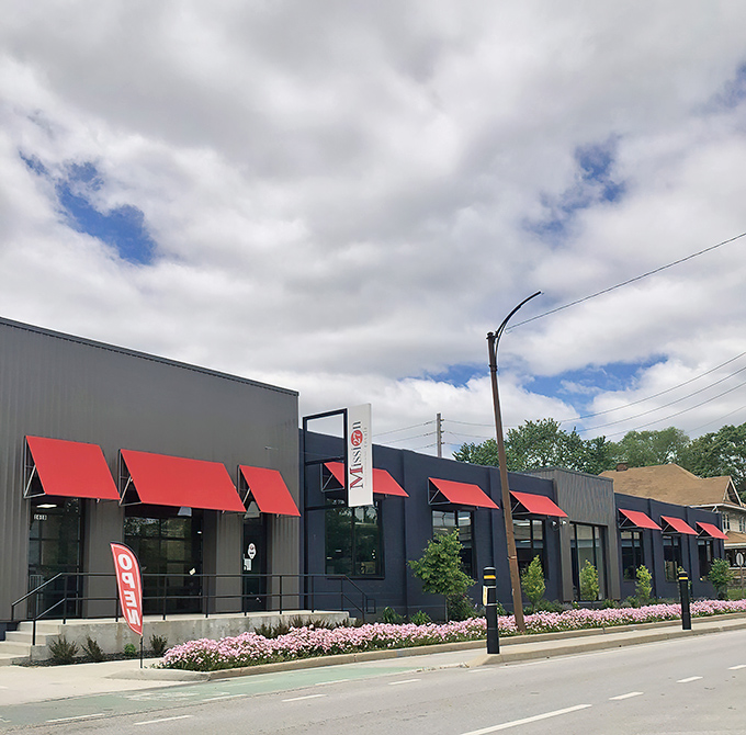The navy-blue exterior with striking red awnings stands like a beacon for treasure hunters on Shelby Street. Thrift nirvana awaits inside.