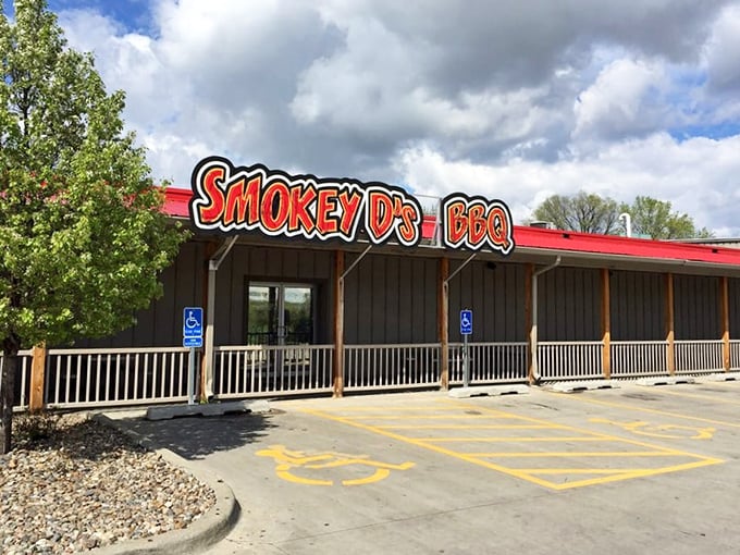 The neon-red sign of Smokey D's BBQ glows like a beacon for hungry souls, promising salvation through smoke and meat in Des Moines.
