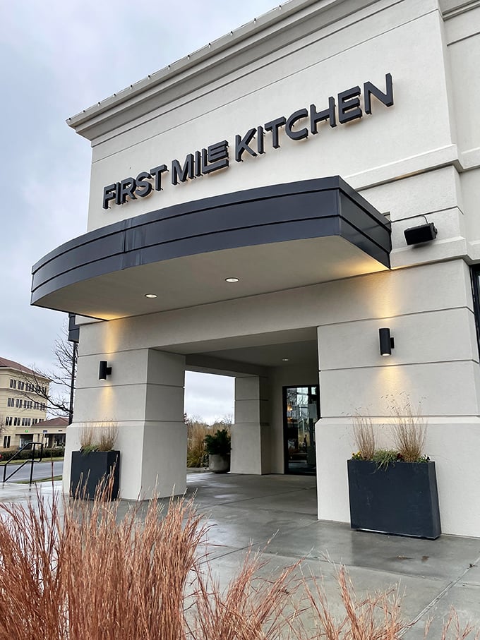 First Mile Kitchen's illuminated sign beckons hungry travelers like a culinary lighthouse in Wichita's Bradley Fair shopping district.