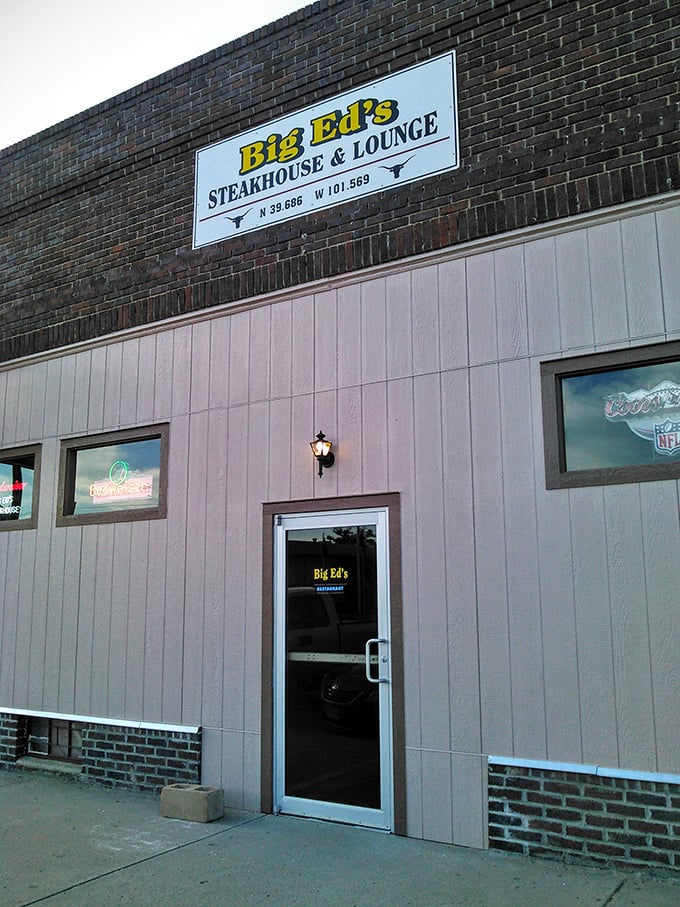 The yellow sign beckons like a prairie lighthouse, guiding hungry travelers to this brick-faced beacon of beef in Bird City.