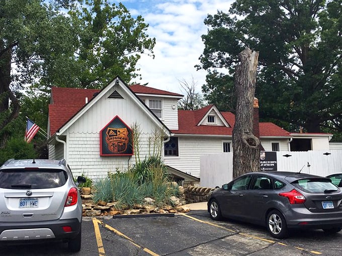 The charming cottage-like exterior of Grinders Stonewall beckons with its red-trimmed sign and helpful "ENTER OVER HERE" arrow&mdash;like your coolest friend's secret hideaway.