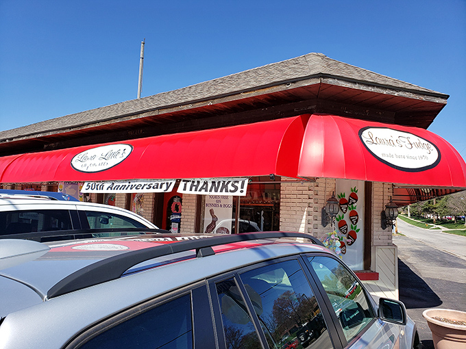 The iconic red awning of Laura Little's Candy Kitchen beckons like a sweet siren call, promising sugary treasures within this Prairie Village landmark.