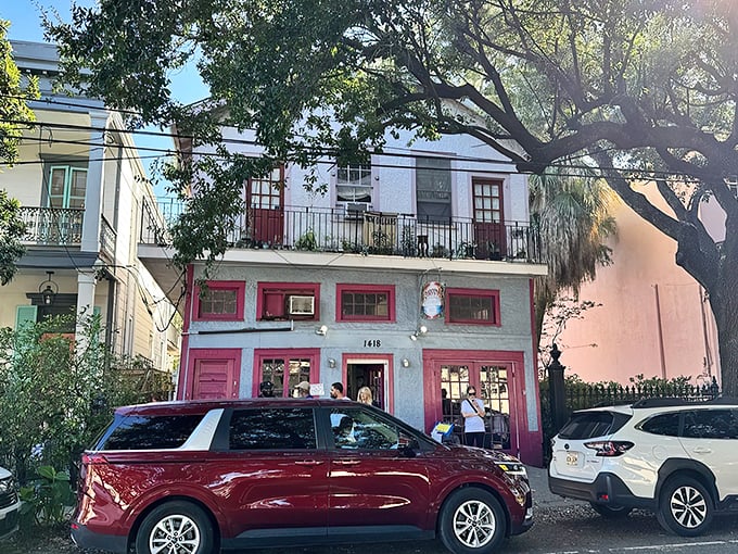The pink-trimmed facade of Surrey's stands out on Magazine Street like a culinary beacon, promising breakfast treasures within those colorful walls.